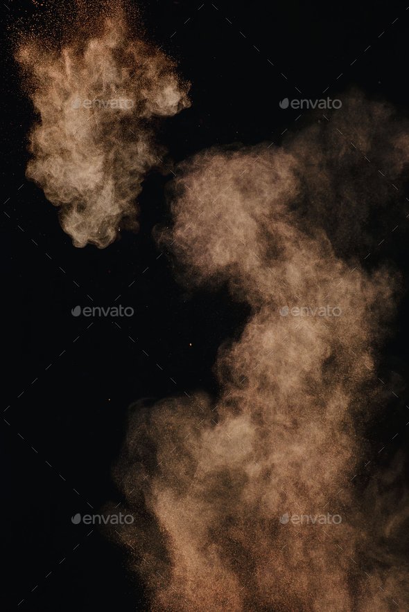 Cocoa powder explosion in motion. Chocolate dust on a black background ...