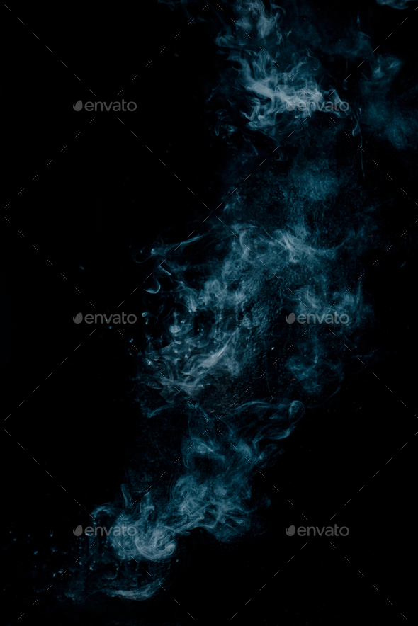 Steam texture from a hot drink on a black background. Blue smoke with ...