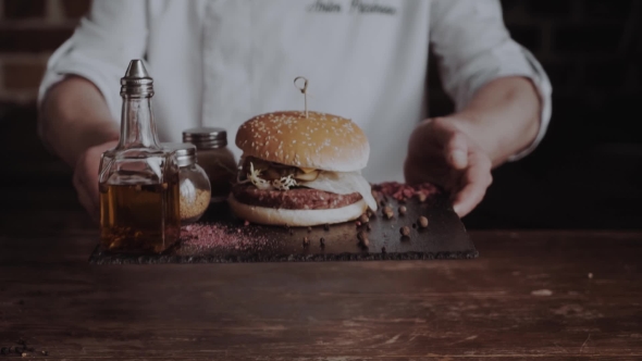 Chief Cook Preparing Fresh Burger in the kitchen.Burger Restaurant Menu ...