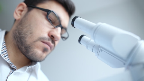 Young Scientist Looking Through Microscope, Stock Footage | VideoHive
