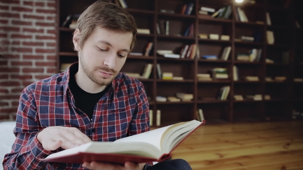 Young Handsome Caucasian Man Reading Book in Home Interior, Stock Footage