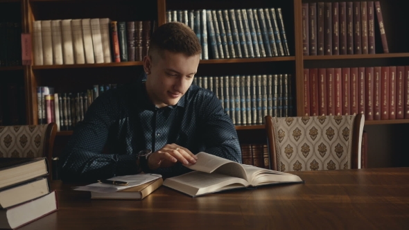 The Guy Flips Through the Book, Stock Footage | VideoHive