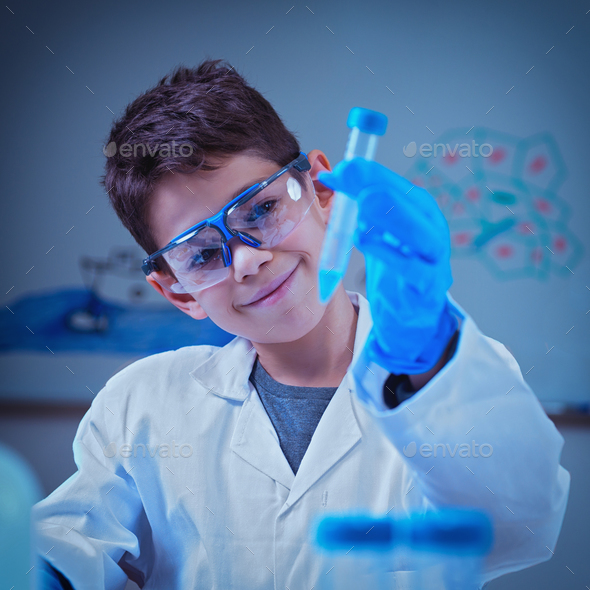 Boy in lab coat holding test tube Stock Photo by microgen | PhotoDune