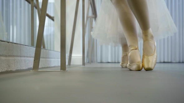 Two Ballet Dancers Stand on Their Toes in Ballet Studio Indoors, Stock ...