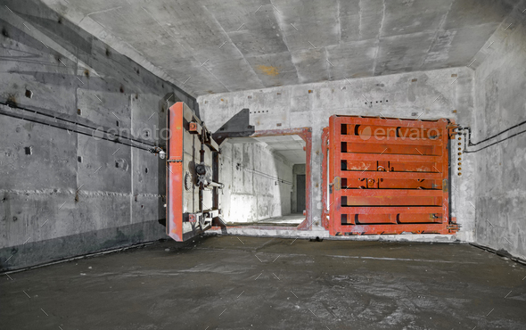 Concrete room underground with a ladder to the surface from which the ...