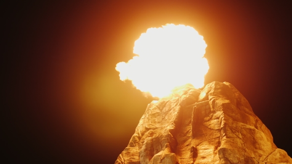 An Artificial Volcano Erupts Into a Fire. Evening in the Amusement Park ...