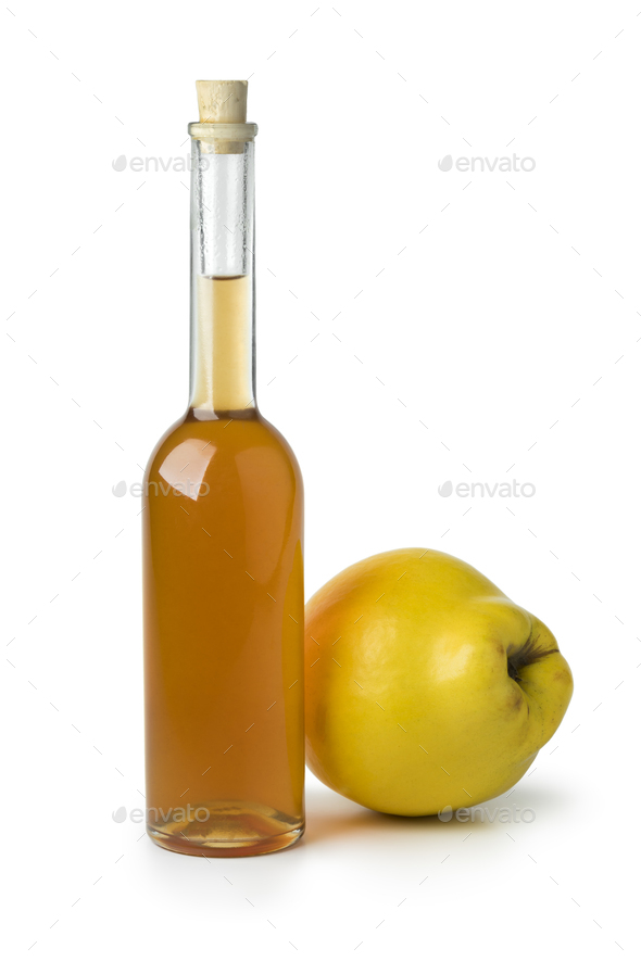 Glass bottle of homemade quince liqueur Stock Photo by picturepartners