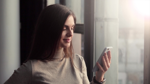 Woman Using Phone Near Window, Stock Footage | VideoHive