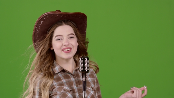 Singer in the Image of a Cowboy Sings in a Retro Microphone. Green ...