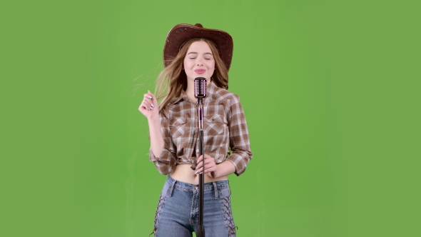 Singer in the Image of a Cowboy Sings in a Retro Microphone. Green ...