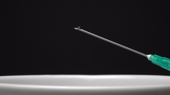 of Syringe Needle with Drop Isolated on Black Background. Water Drop ...