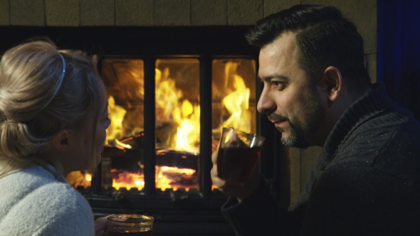 Romantic Couple Relaxing in Front of a Fire, Stock Footage | VideoHive