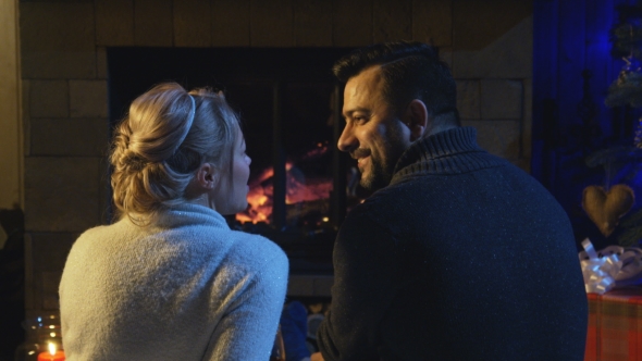 Married Couple Sitting in Front of a Burning Fire, Stock Footage ...