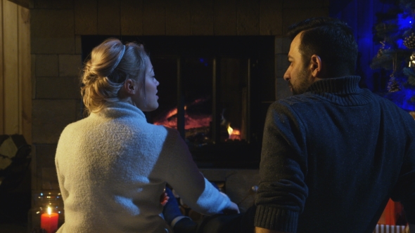 Married Couple Sitting in Front of a Burning Fire, Stock Footage ...