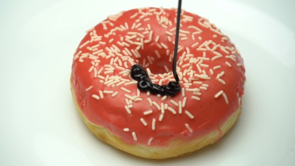 Delicious Sweet Red Donut Rotating on a Plate. Pouring Chocolate. Side ...