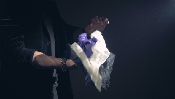 A Pile of Multicolored Cloths Is Appearing in Magician's Right Hand ...