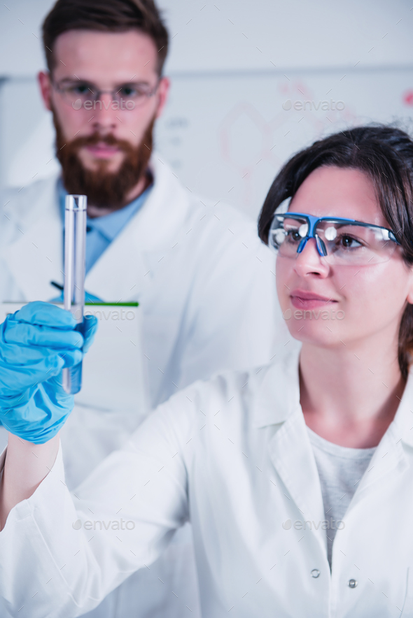 Young Scientist Doing Experiments In The Laboratory Stock Photo by microgen