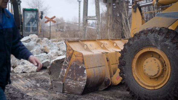 Bulldozer Is Moving Large Piece of Stone, Jackhammer on Basis of ...