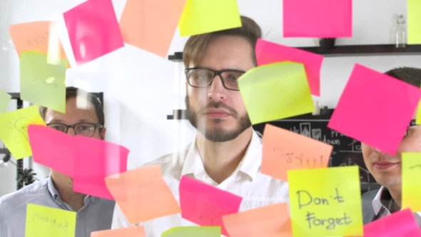 Man Post in Sticky Note While Meeting in Office on the Sticker Is ...