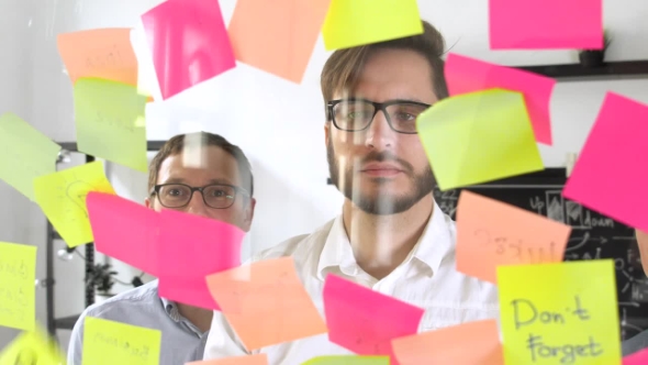 Man Post in Sticky Note While Meeting in Office on the Sticker Is ...