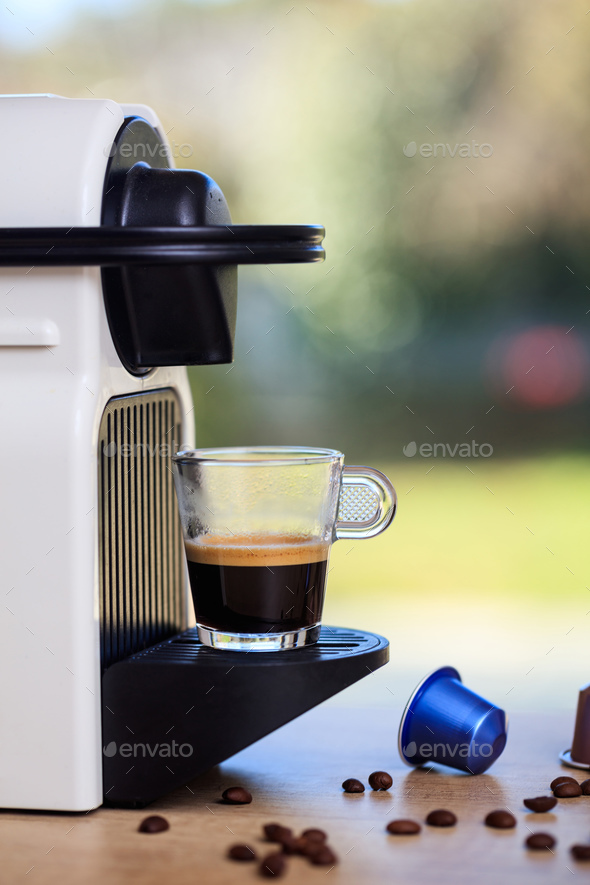 Espresso coffee machine on a wooden table, blur green background Stock ...