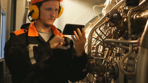The Engineer Checks the Operation of the Turbine Using a Smartphone ...