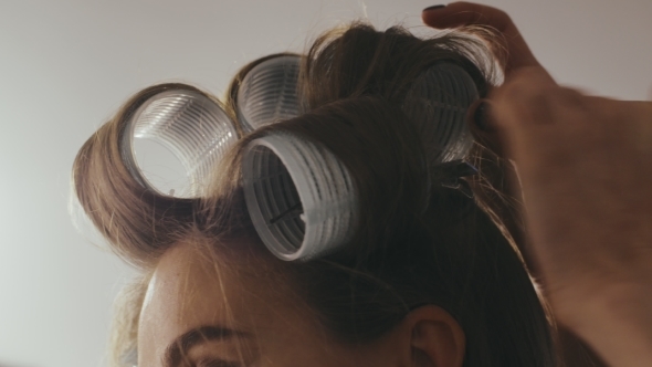 Female Hand Hairdresser Take Off Hair Curlers From Head Woman with Long ...