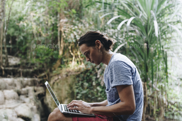 White man using computer laptop at waterfall Stock Photo by Rawpixel