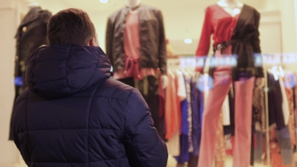 Young Frozen Man Looks at the Shop Window, Stock Footage | VideoHive