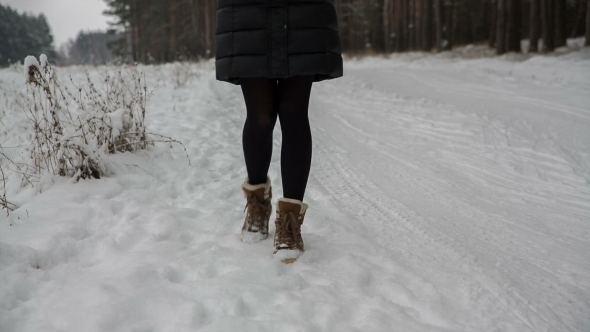 Legs of Woman Walking on Snow with Footprints on Snowy Day, Stock Footage
