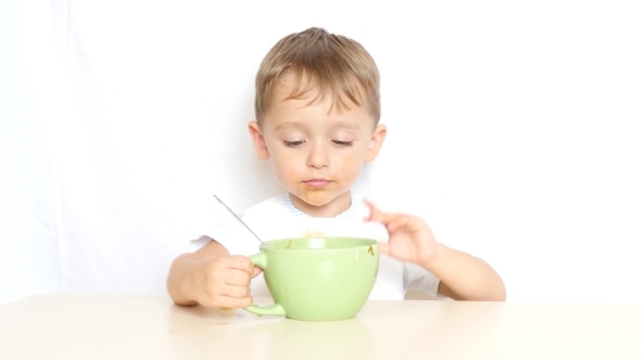 The Child Boy Sitting at the Table Finished Eating Food and Pushed His ...