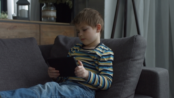 Preschool Kid Using Digital Tablet for Playing Game, Stock Footage