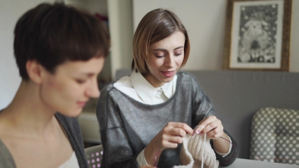 Two Young Woman Knitting Wool Yarn Together in Textile Workshop ...