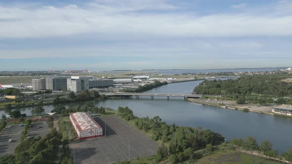 Aerial zoom in view towards highway and bridge near the airport ...