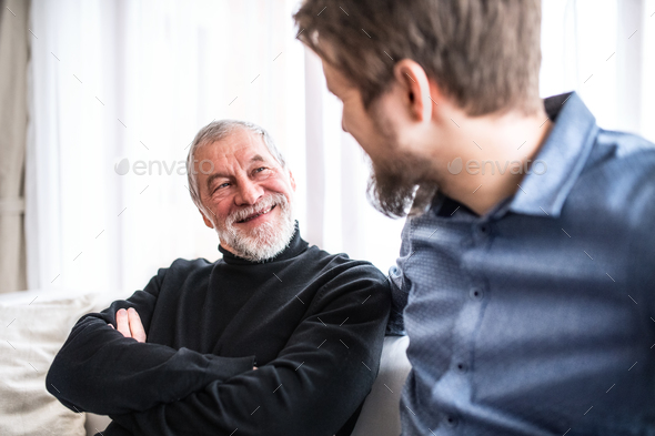 Hipster son and his senior father at home. Stock Photo by halfpoint