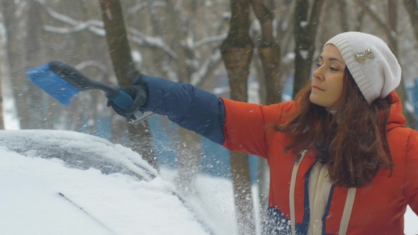 Girl in Clearing the Car From Snow, Stock Footage | VideoHive