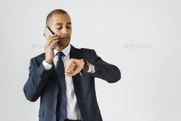 Businessman talking on call checking time fro wrist watch Stock Photo ...