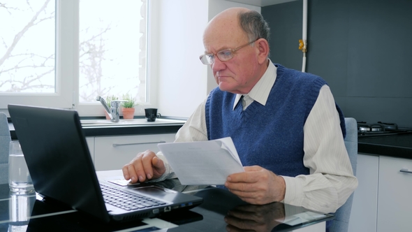 Grandfather Works in Internet on Computer with Documents Into Hands ...