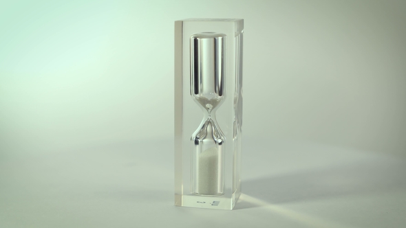 Modern Glass Hourglasses Rotate Against a White Background, Stock Footage