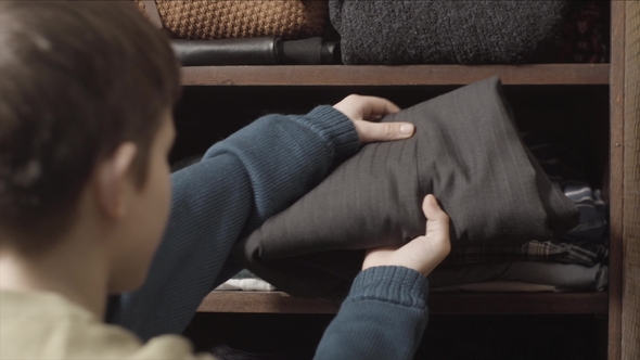 The Child Puts His Clothes On. The Boy Pulls the T-shirt Out of the ...