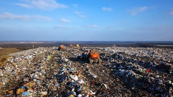 City Dump The Bulldozer Compacts the Garbage on the Landfill Wastes of ...