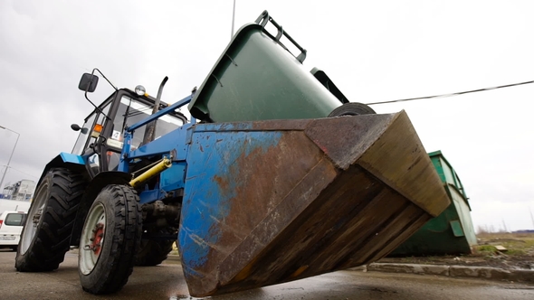 The Tractor Lowers the Garbage Container. Slider, Stock Footage | VideoHive