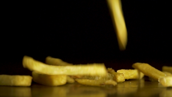 French Fries Fall on the Table Isolated on Black Background. Fastfood ...