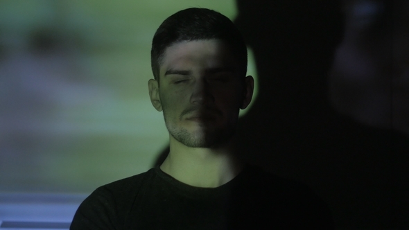 Portrait of Young Man Watching a Video or Film on TV or a Computer ...