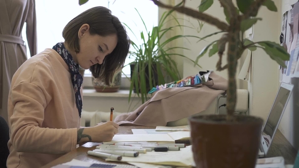 Portrait of Female Fashion Designer, Who Is Working on the Sketch of ...