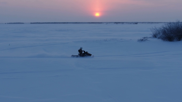 At Sunset a Snowmobile is Riding Across the Arctic, Stock Footage ...