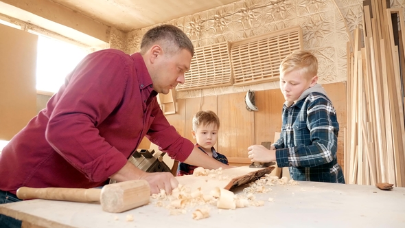 Family, Carpentry, Woodwork and People Concept. Father Teaches Son ...