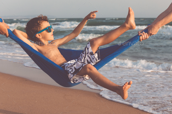 Happy little boy relaxing on the beach at the day time Stock Photo by ...