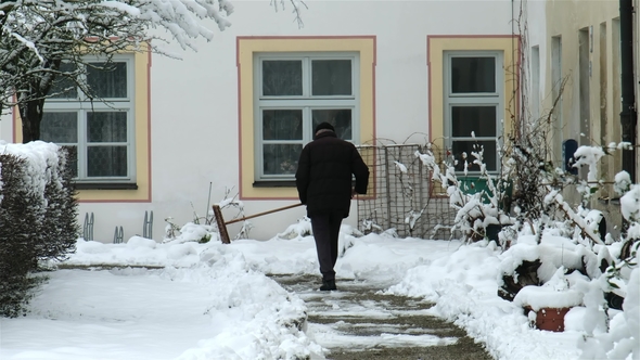 Man Sweeping Snow From the Pavement, Stock Footage | VideoHive