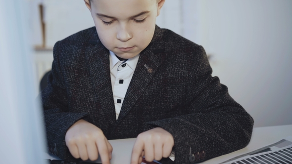 Little Handsome Boy Hard Working with Computer in Office, Stock Footage